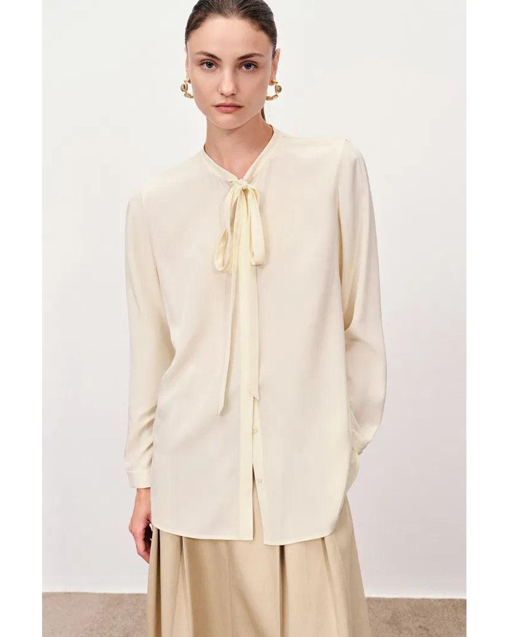 Fabrique Linde Ribbon Tie Flowy Blouse in Natural | Lyst UK