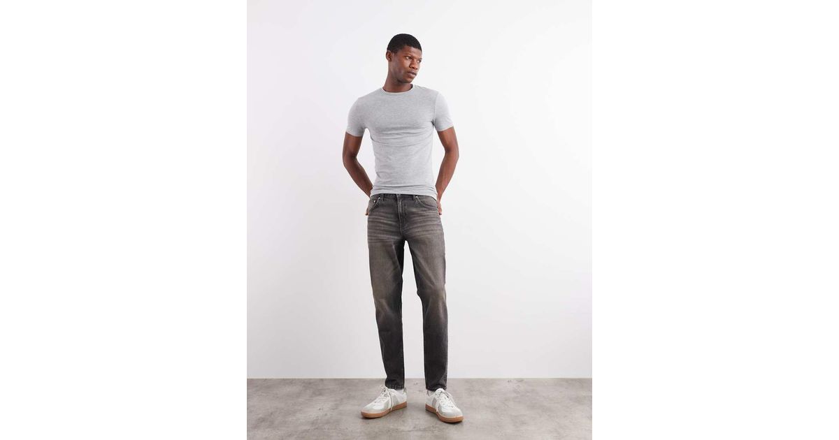 ASOS Tapered Fit Jeans With Yellow Tint in White for Men | Lyst UK