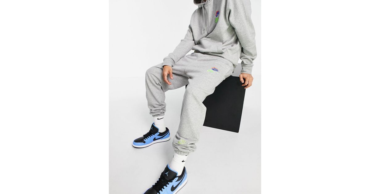 Nike Essential Fleece+ Multi Logo Casual Fit Cuffed Sweatpants in Grey ...