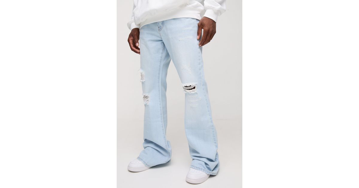 BoohooMAN Relaxed Rigid Flare Stacked Knee Rip Denim Jeans in Blue for ...