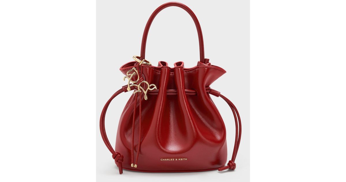 Charles & Keith Sammie Horse-Motif Drawstring Bucket Bag in Red | Lyst UK