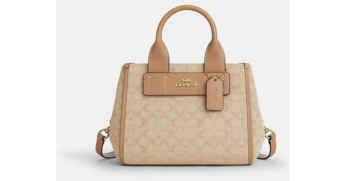 COACH Carly Carryall Bag With Signature Canvas in Black | Lyst UK