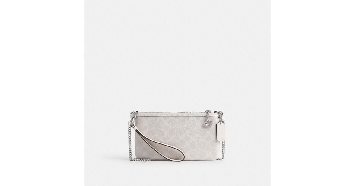 COACH Pouch Bag In Signature Canvas in White | Lyst Canada