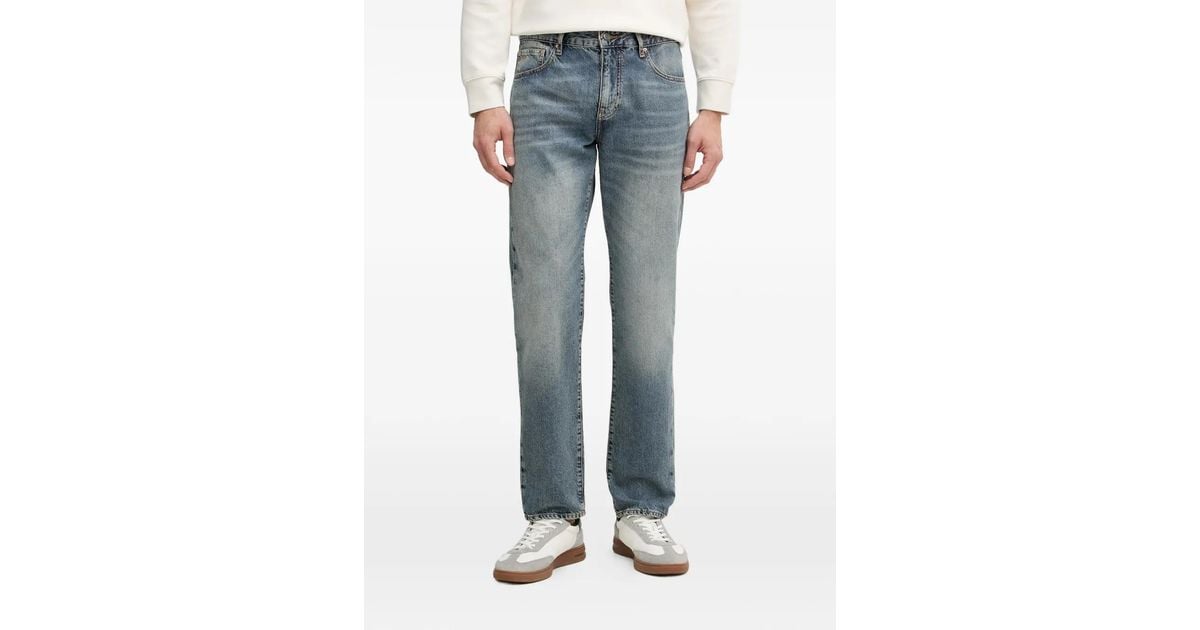 ARMANI EXCHANGE Logo-Embroidered Stonewashed Jeans in Blue for Men ...