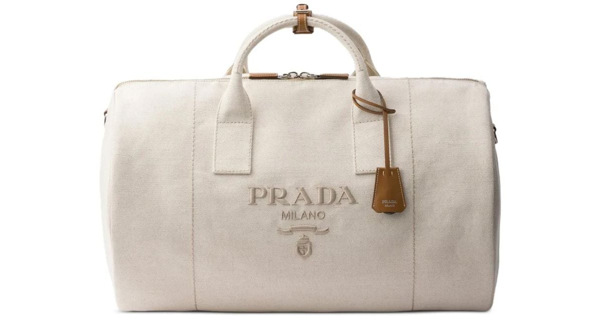 Prada Logo-Embossed Duffle Bag in Natural | Lyst