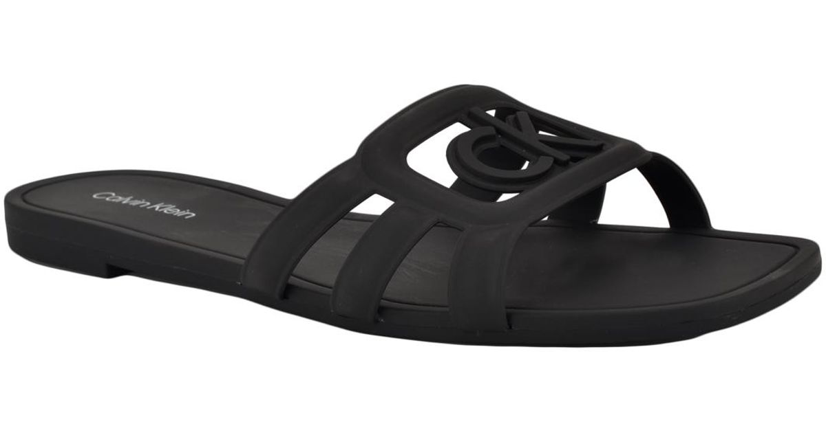 Calvin Klein Yoana Logo Slip-on Jelly Flat Sandals in Black | Lyst