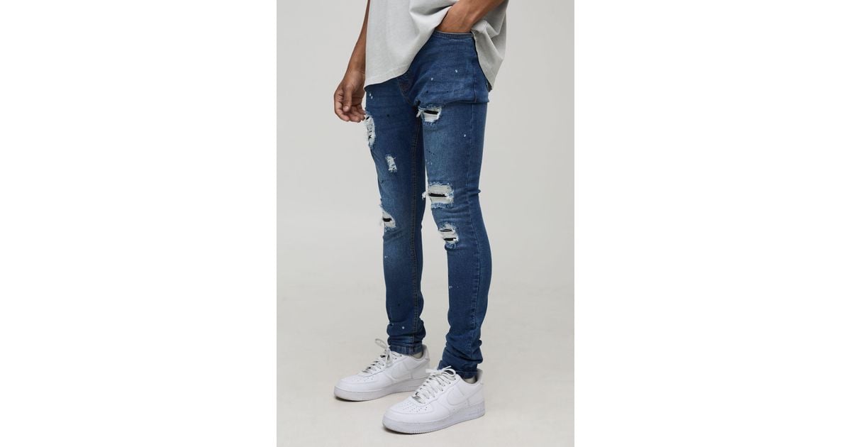 BoohooMAN Super Skinny Stacked Rip & Repair Paint Splatter Jeans in ...
