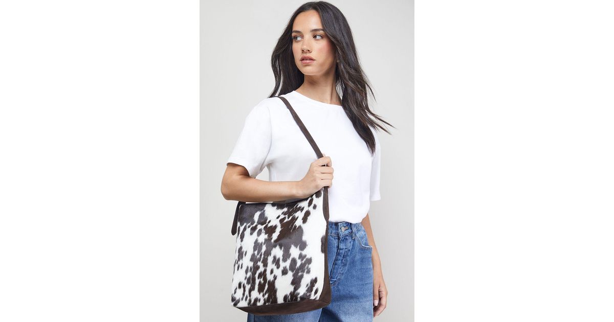 Oasis Lilah Cow Print Pony Leather Slouch Bag in White | Lyst UK