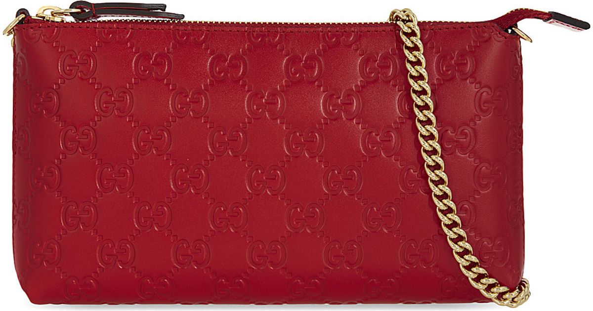 Gucci GG Signature Embossed Leather Clutch in Red | Lyst