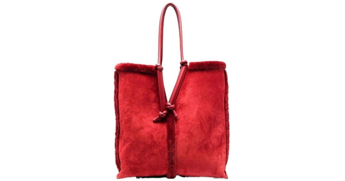 Bottega Veneta Bolster Reversible Shearling Suede Bag in Red | Lyst