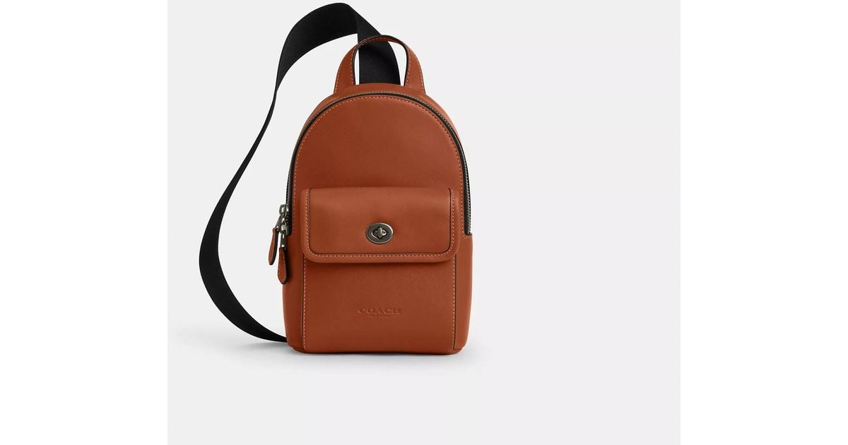 COACH Small Turnlock Sling Pack in Brown | Lyst