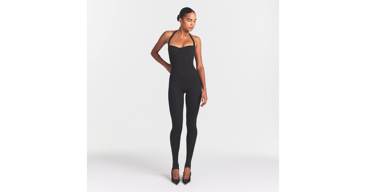 Skims Halter Stirrup Catsuit in Black | Lyst