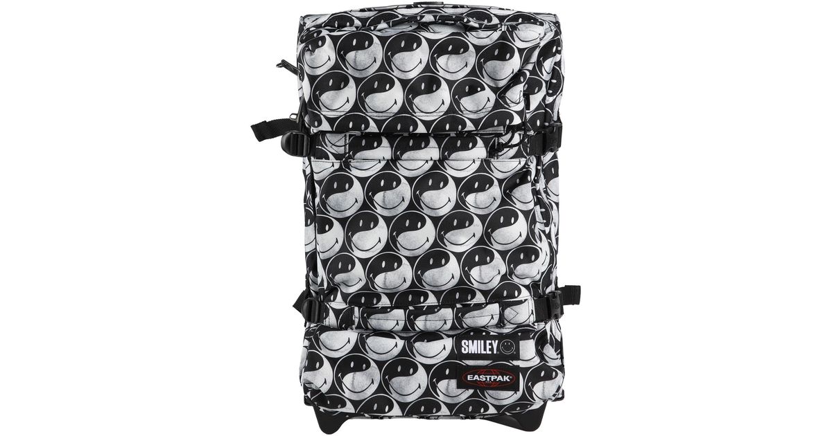 SMILEY® x EASTPAK Wheeled luggage in Black | Lyst