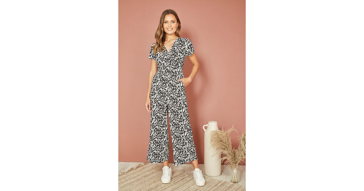 Yumi' And Wrap Over Stretch Jumpsuit in Black | Lyst UK