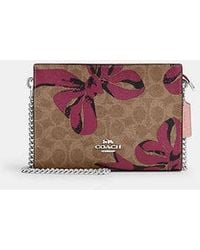 COACH Slim Crossbody Bag In Signature Canvas With Bow Print in Black | Lyst