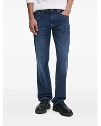 Guess Finnley Logo Patch Jeans in Blue for Men | Lyst UK