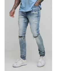 BoohooMAN Super Skinny Stacked Rip & Repair Paint Splatter Jeans in ...