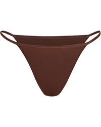 Women's Skims Beachwear and swimwear outfits from $16 | Lyst