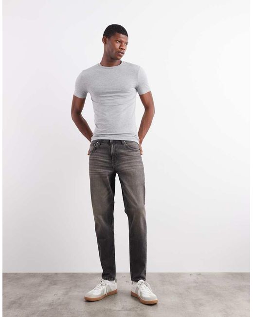 ASOS Tapered Fit Jeans With Yellow Tint in White for Men | Lyst UK