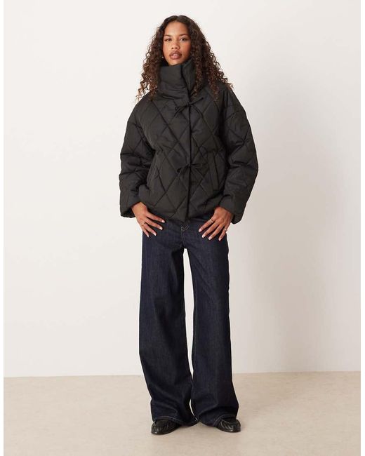 Vila High Neck Quilted Jacket With Tie Details in Black | Lyst UK