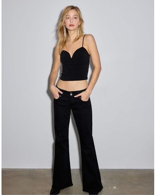 Stradivarius Low-rise Bell Bottom Jeans With Two Metal Buttons in Black ...