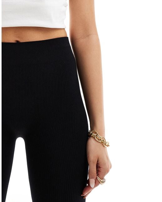 Stradivarius Seamless Ribbed Flare Trouser in Black | Lyst