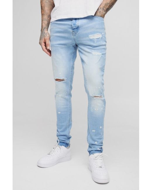 BoohooMAN Tall Skinny All Over Ripped Bleached Paint Splatter Jeans in ...