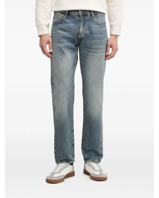 ARMANI EXCHANGE Logo-Embroidered Stonewashed Jeans in Blue for Men ...