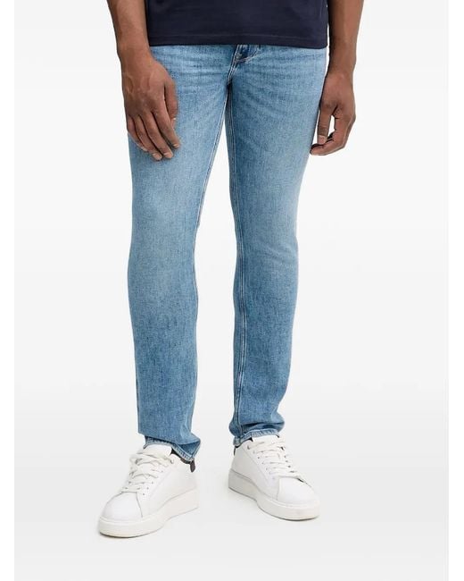 Guess Finnley Logo Patch Jeans in Blue for Men | Lyst UK