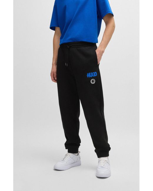HUGO Cotton-terry Tracksuit Bottoms With Smiley-face Logo in Black for ...