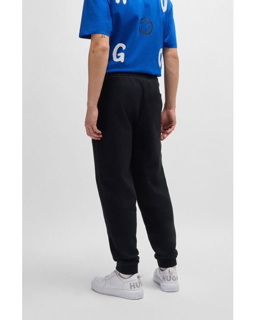 HUGO Cotton-terry Tracksuit Bottoms With Smiley-face Logo in Black for ...