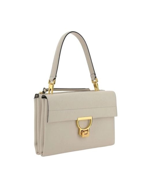 Coccinelle Handbags in Natural | Lyst