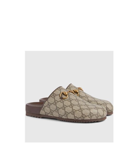 Gucci Monogrammed Gancini Plaque Slides in Brown | Lyst