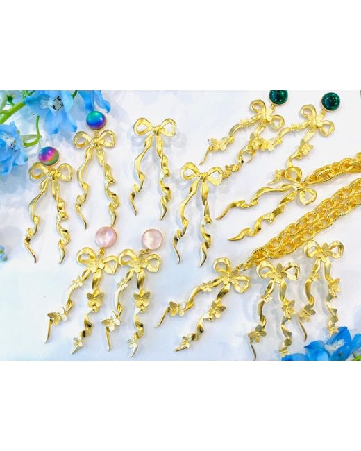 The Pink Reef Elongated Bow in Metallic | Lyst UK